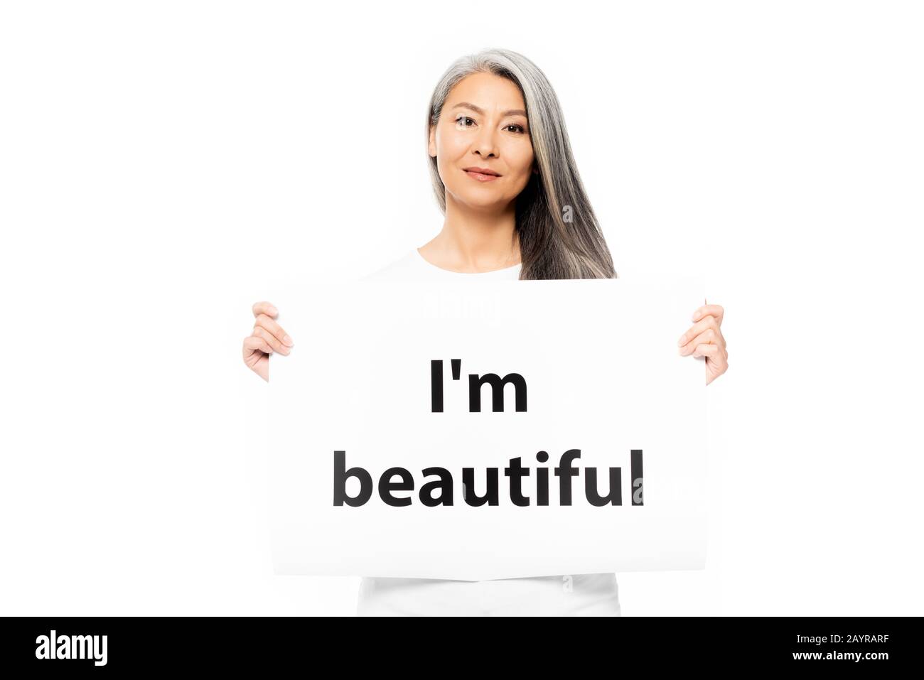 cheerful asian woman holding placard with i`m beautiful lettering ...