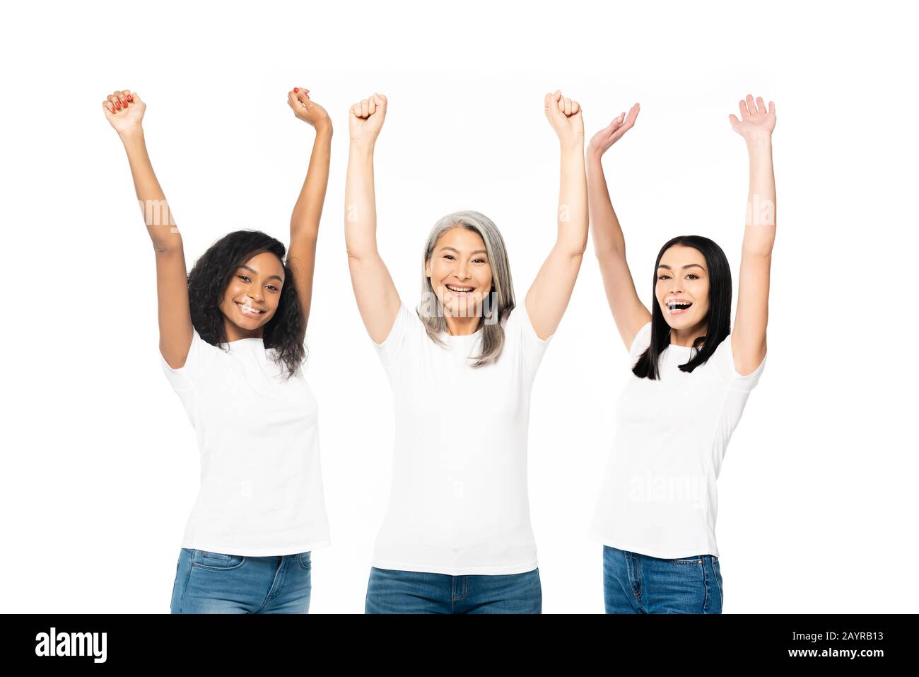 cheerful multicultural women with hands above head celebrating isolated ...