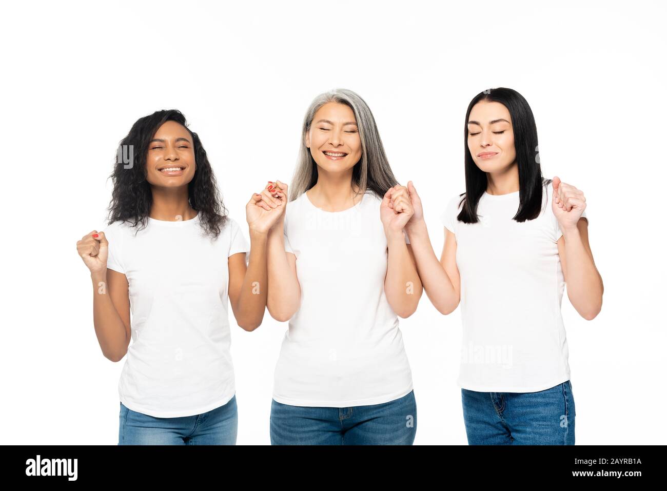smiling multicultural women with closed eyes holding hands isolated on ...