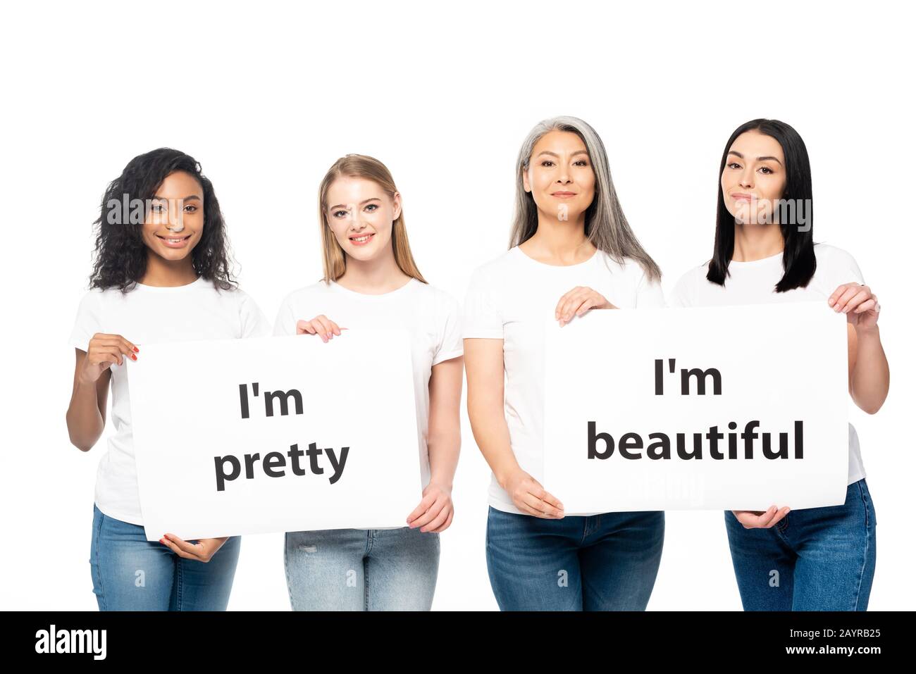 happy multicultural women in denim jeans holding placards with ...