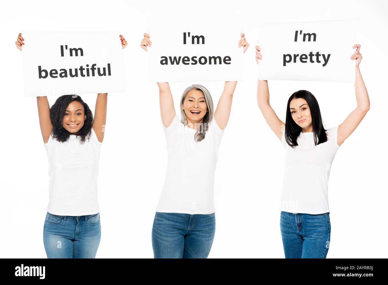 happy multicultural women holding posters with lettering above head ...