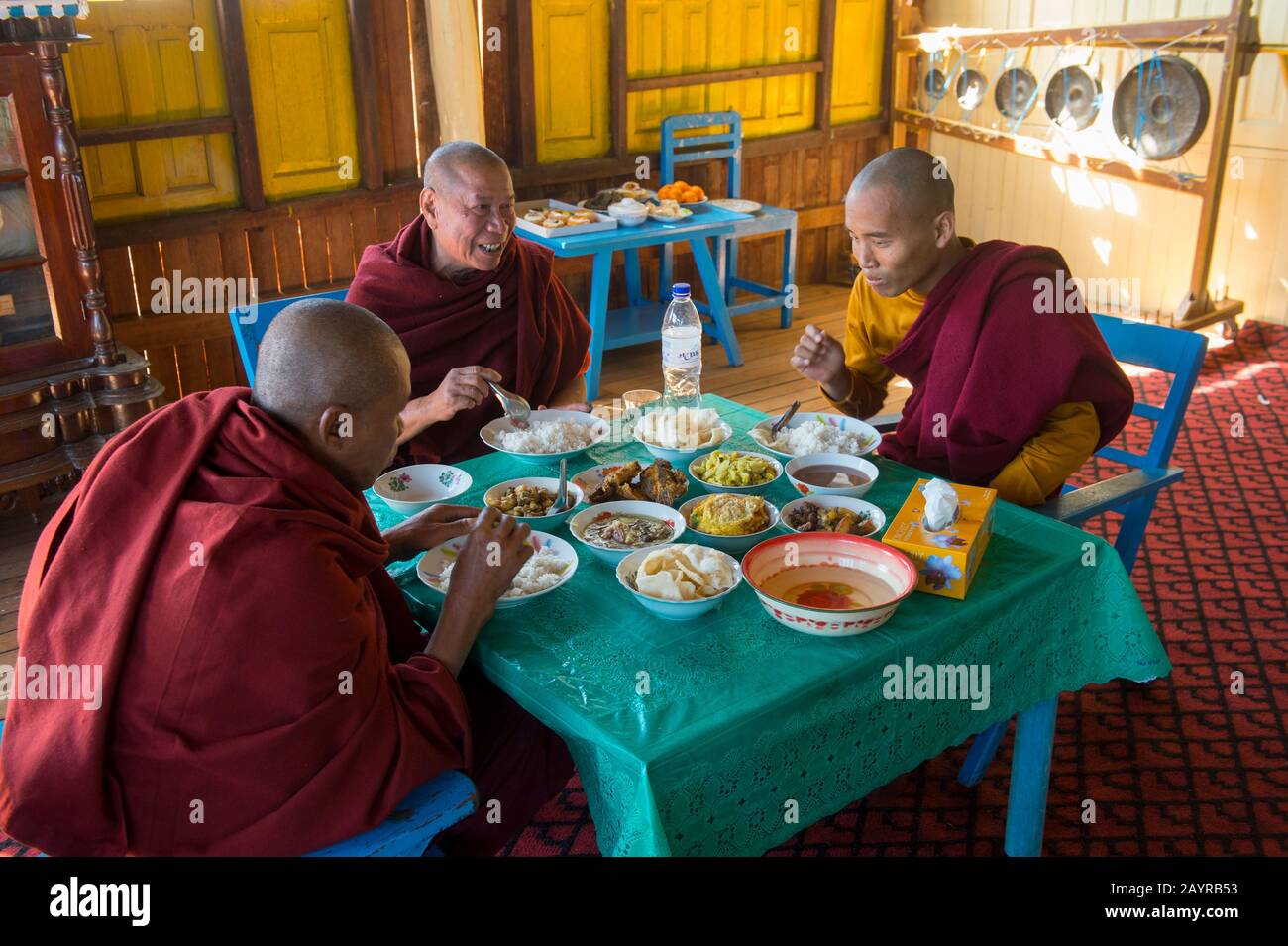 Buddhist monks eating a meal in a monastery in the village of Kuwoo on ...