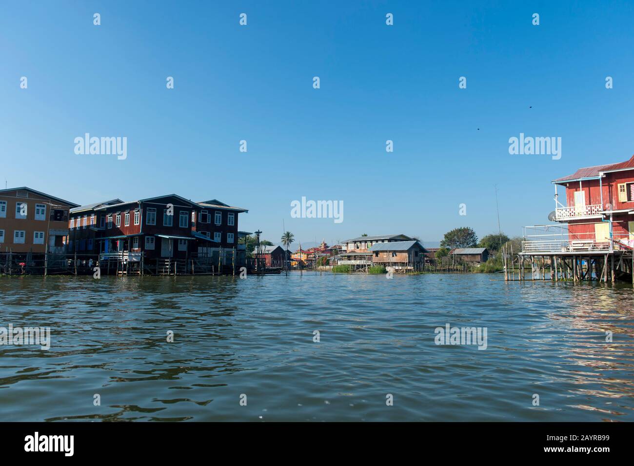 A village scene with houses on stilts in a village in Inle Lake in ...