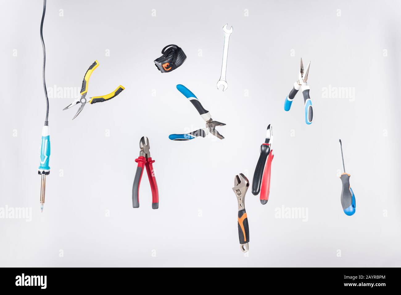 Set of tools levitating in air isolated on grey Stock Photo - Alamy
