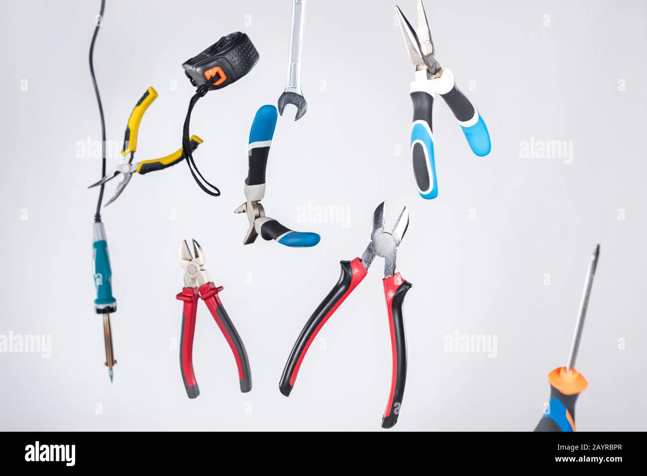 Set of tools with pliers and measuring tape levitating in air isolated ...