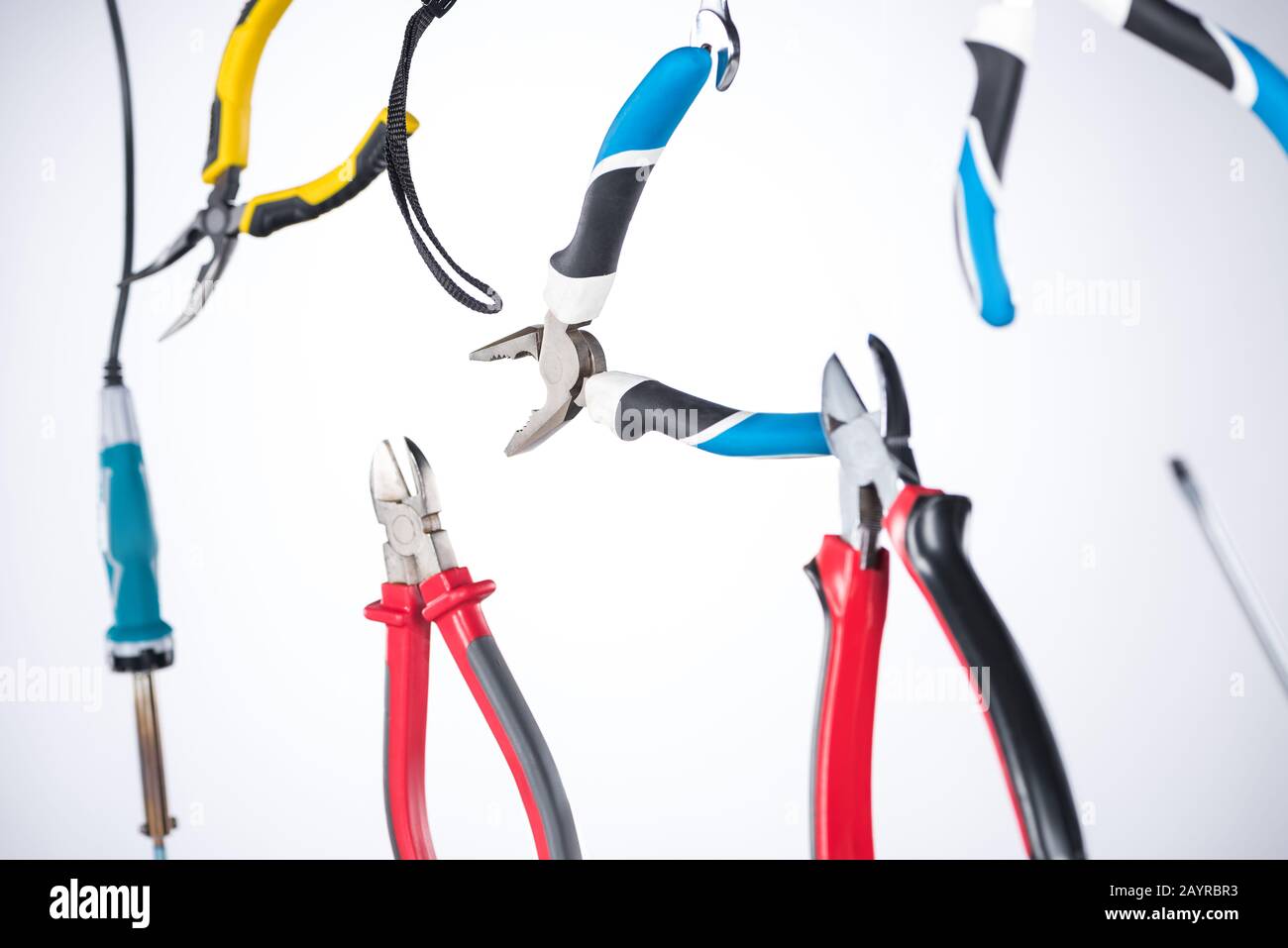 Selective focus of pliers and tools levitating in air isolated on grey ...
