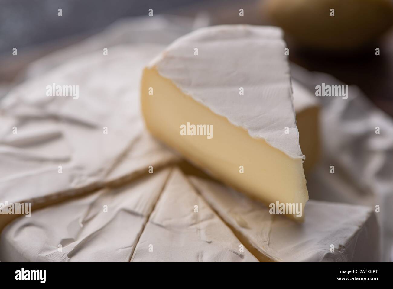 close up view of cut brie cheese piece Stock Photo - Alamy