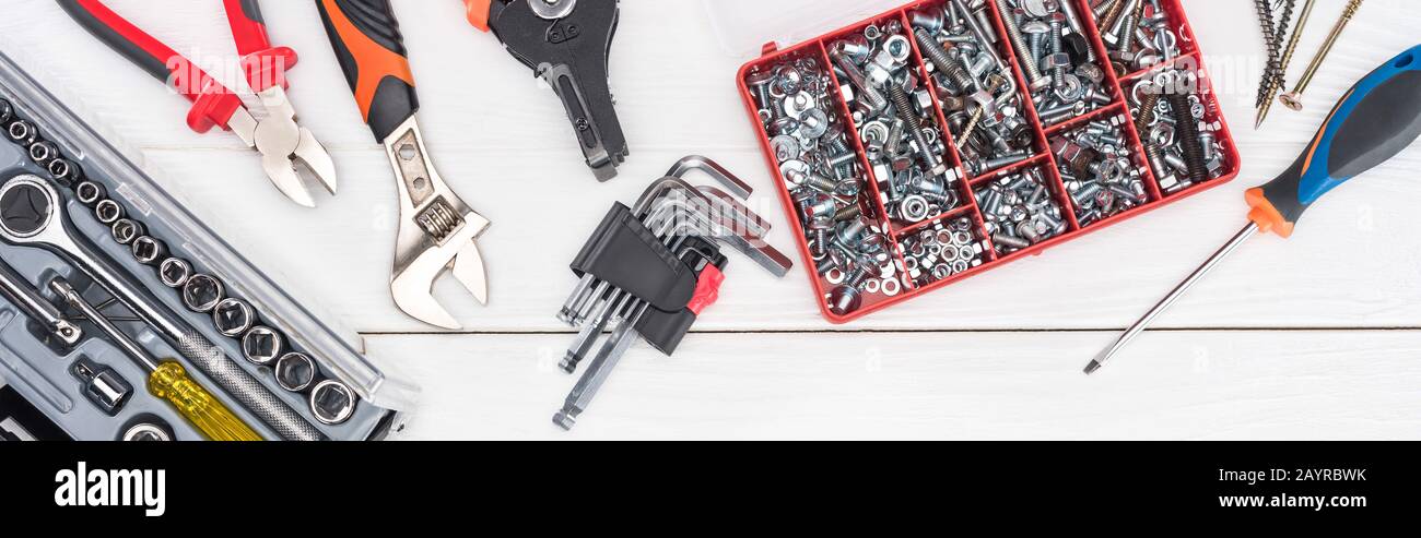 Top view of tools with tool boxes on white wooden surface, panoramic ...