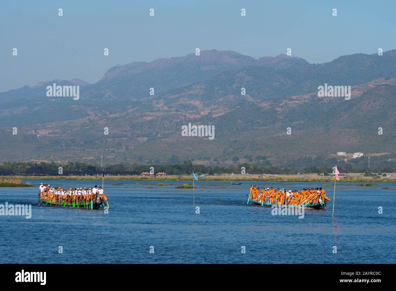 A traditional leg-rowing boat race accompanied with music on Inle Lake ...