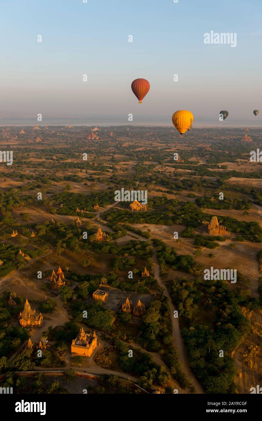 Hot air balloons are flying over Bagan, Myanmar in the early morning ...