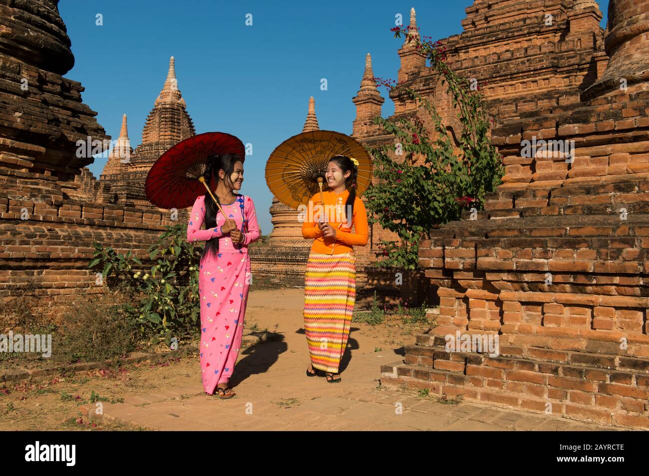 A model shoot with two young women in traditional dress and parasols at ...
