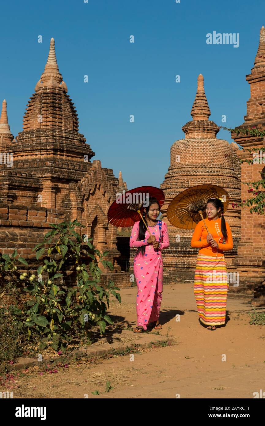 A model shoot with two young women in traditional dress and parasols at ...