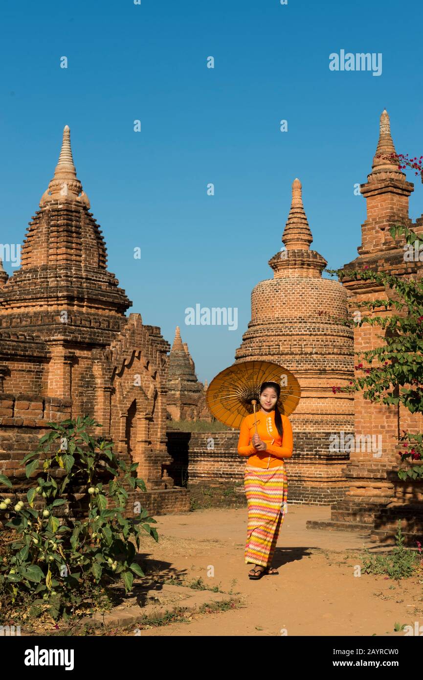 A model shoot with a young woman in traditional dress and a parasol at ...