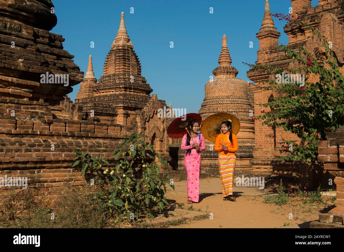 A model shoot with two young women in traditional dress and parasols at ...