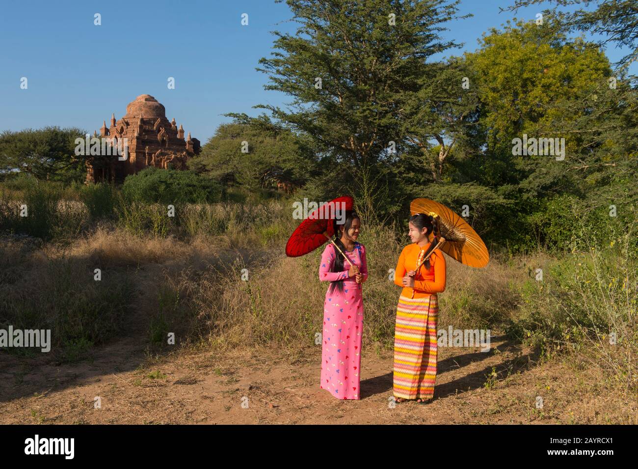 A model shoot with two young women in traditional dress and parasols ...