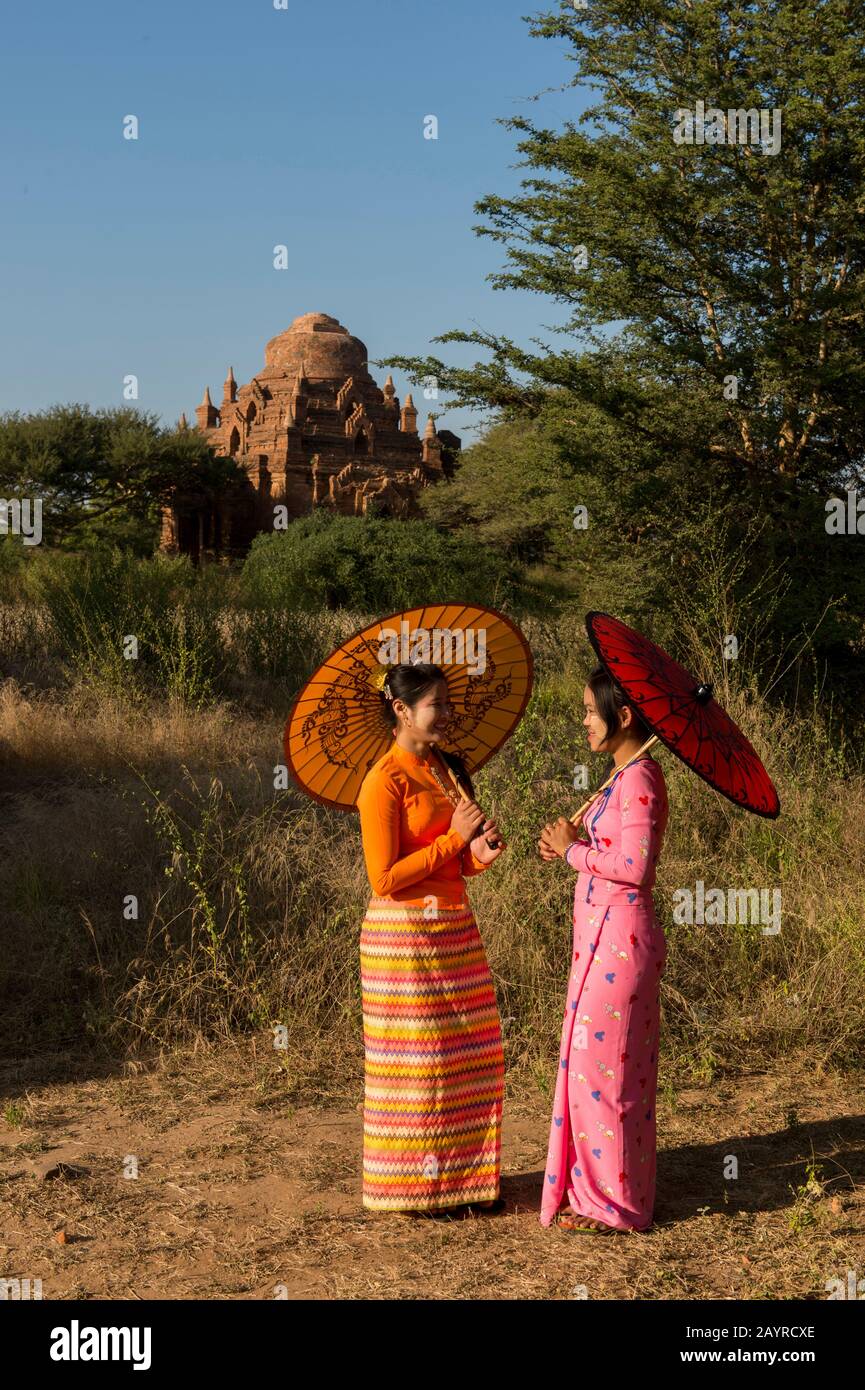 A model shoot with two young women in traditional dress and parasols ...