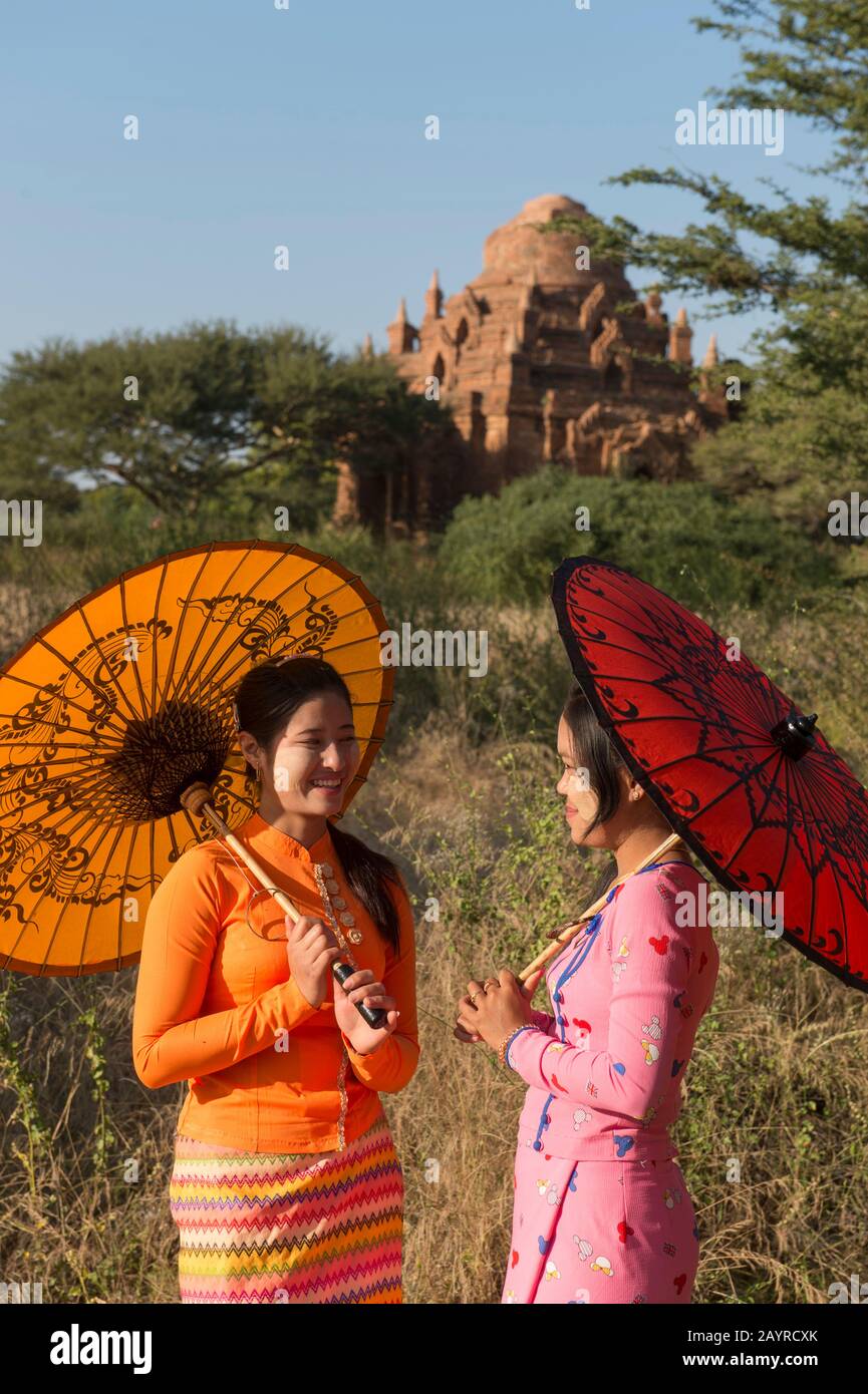 A model shoot with two young women in traditional dress and parasols ...