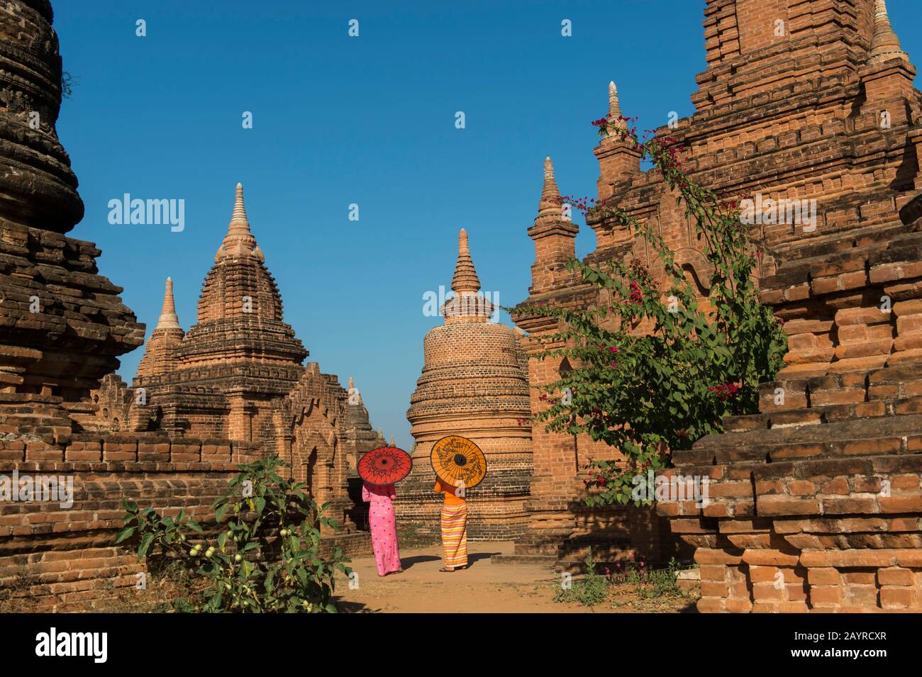 A model shoot with two young women in traditional dress and parasols at ...