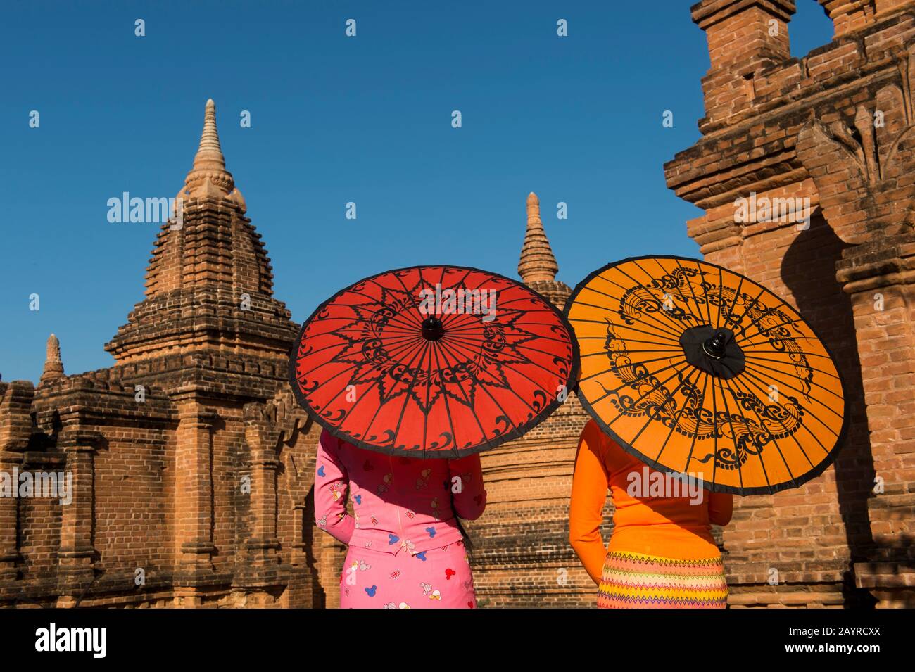 A model shoot with two young women in traditional dress and parasols at ...