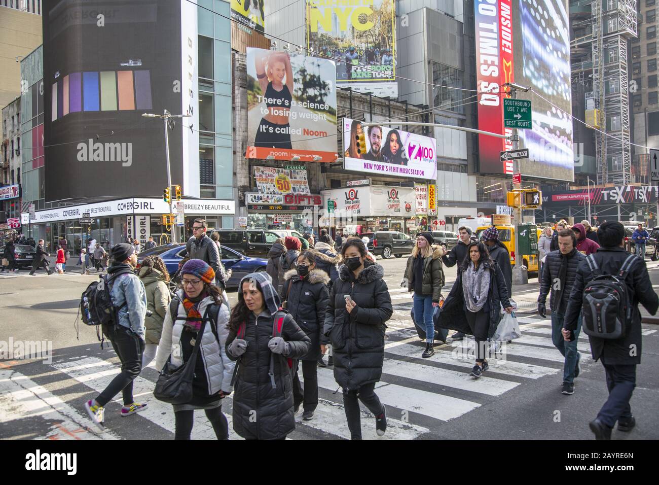Pedestrians in the crosswalk along 7th Avenue in the always busy Times ...