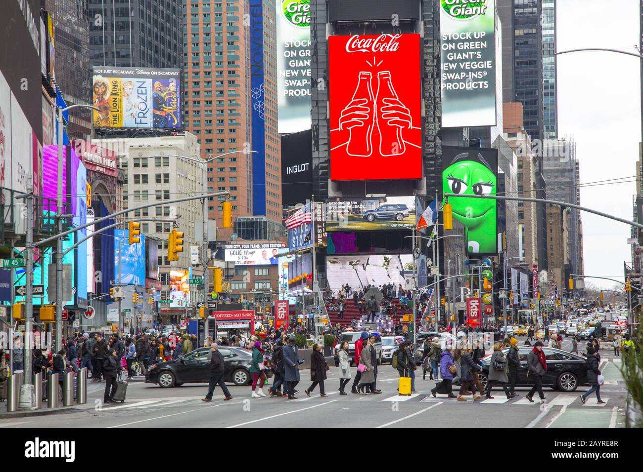 People in the crosswalk where Broadway and 7th Avenue come together in ...