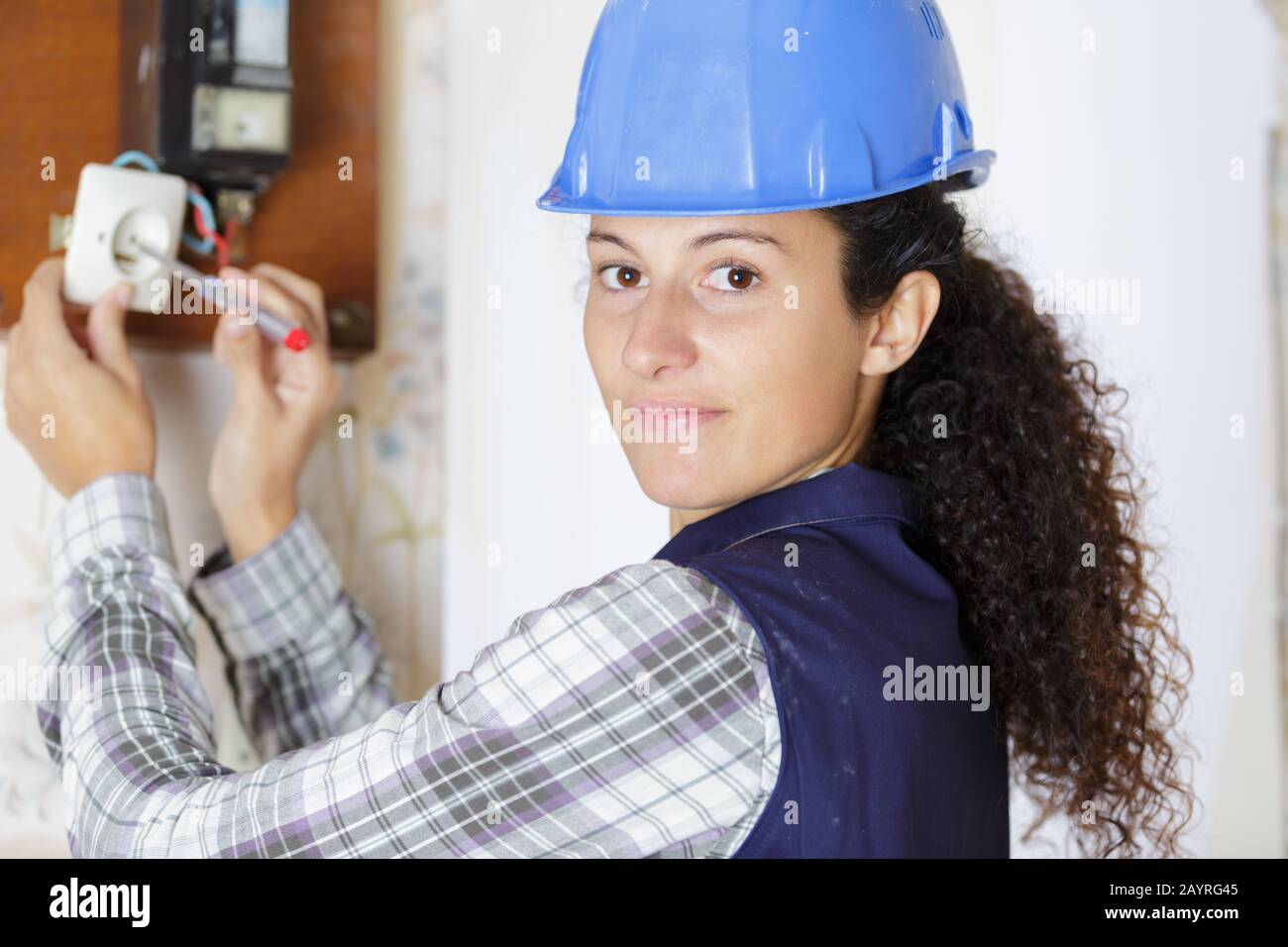 Female electrician fixing socket hi-res stock photography and images ...