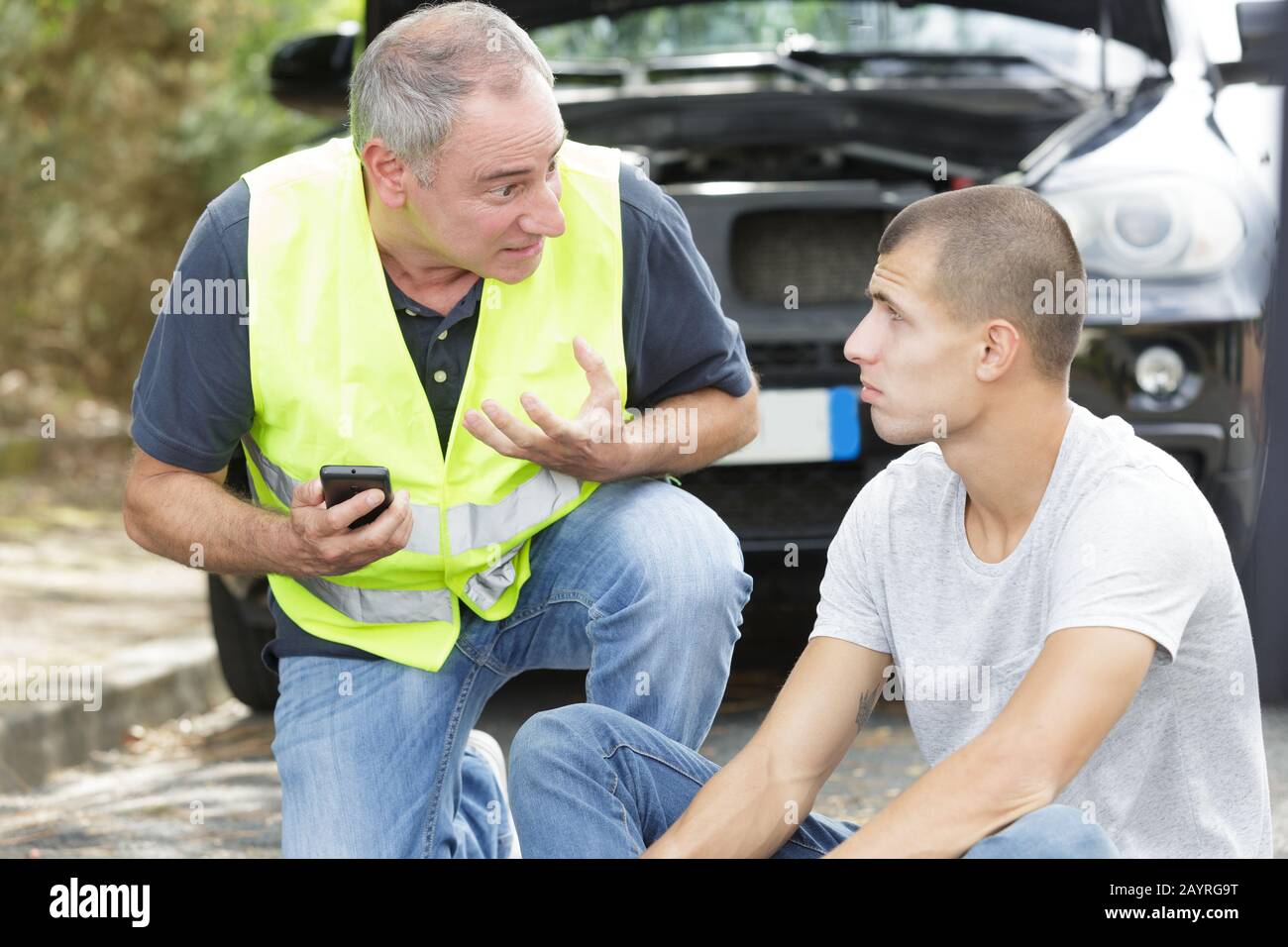 mechanic and customer discussing problem with car Stock Photo - Alamy