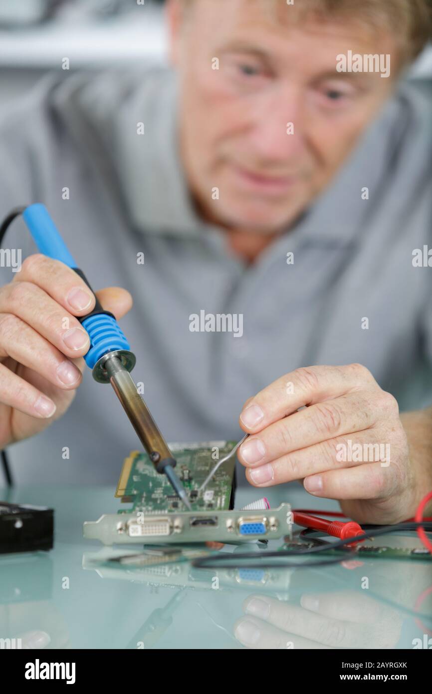 technician repairing a pc by soldering iron in the lab Stock Photo - Alamy