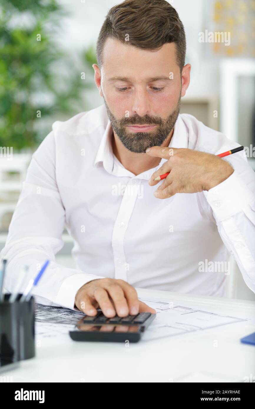 accountant calculating dollars with calculator in office Stock Photo ...