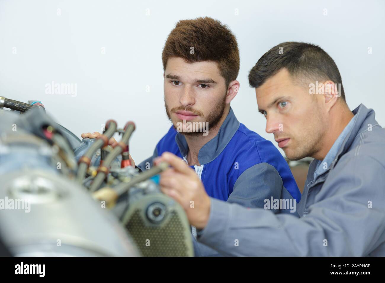 car mechanic man fixing the engine at the garage Stock Photo - Alamy