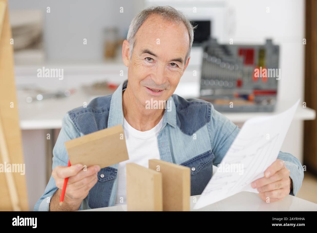senior man following instructions to assemble furniture Stock Photo - Alamy