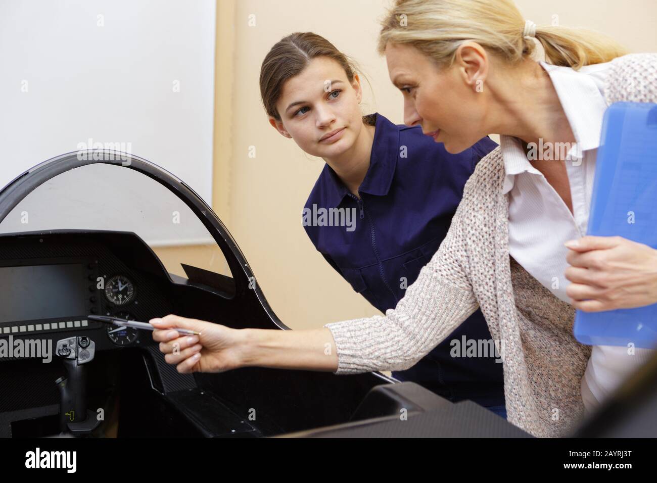female manager and apprentice working on a engine Stock Photo - Alamy