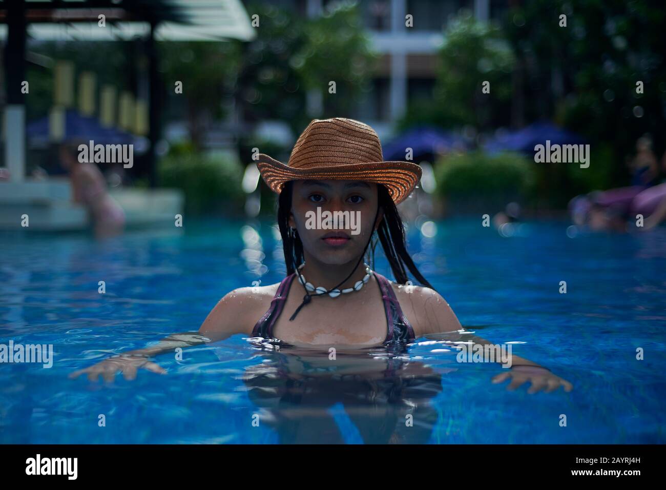 Stylish trendy young teen visco girl wearing a straw hat and shell ...