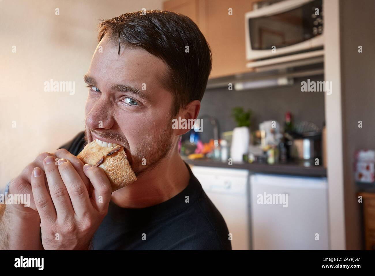 Man biting a sandwich Stock Photo - Alamy