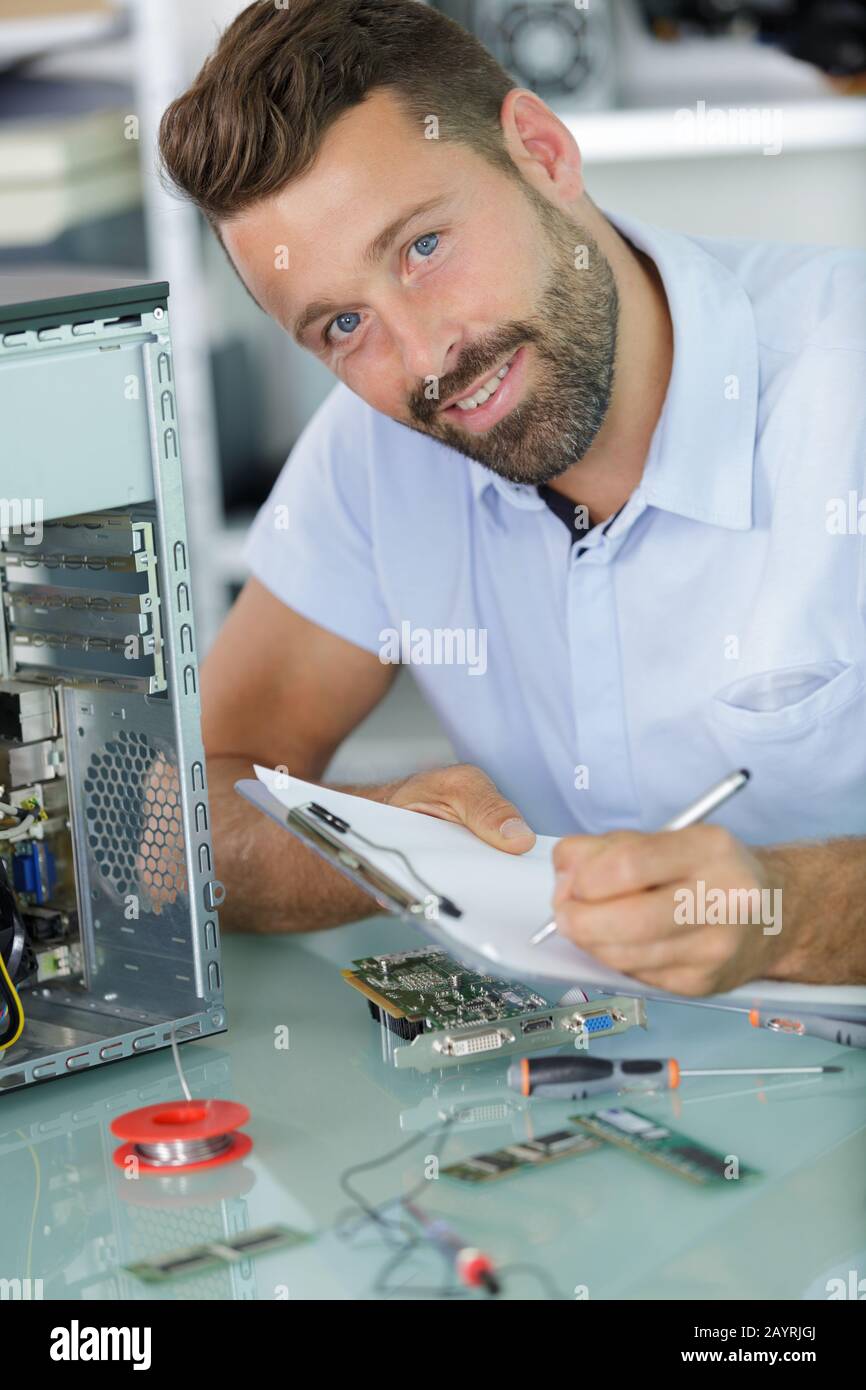 a man is fixing a pc Stock Photo - Alamy