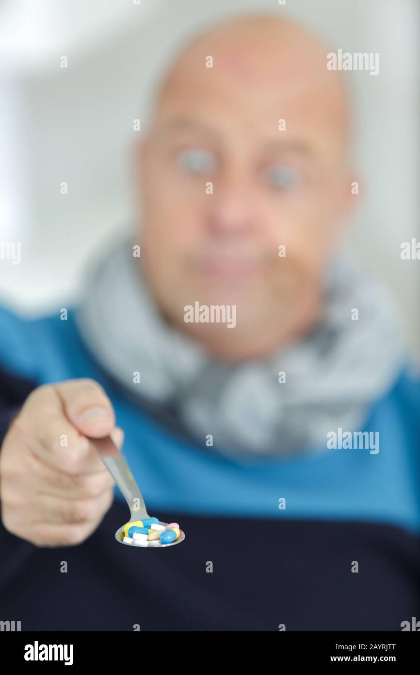 a funny man taking pills Stock Photo - Alamy