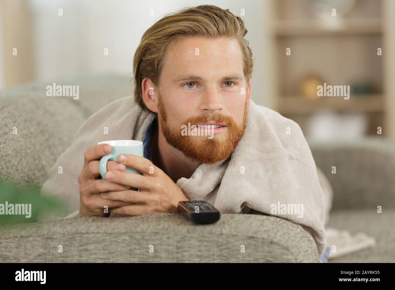 man watching tv at home on floor Stock Photo - Alamy