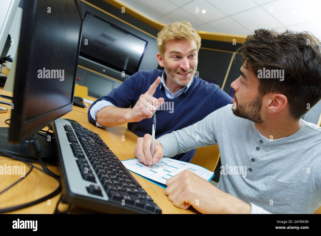 information technology teacher giving advice to student Stock Photo - Alamy