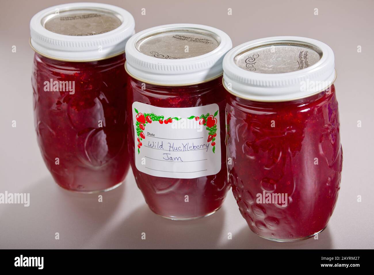 Three jars of homemade wild huckleberry jam, made from red ...