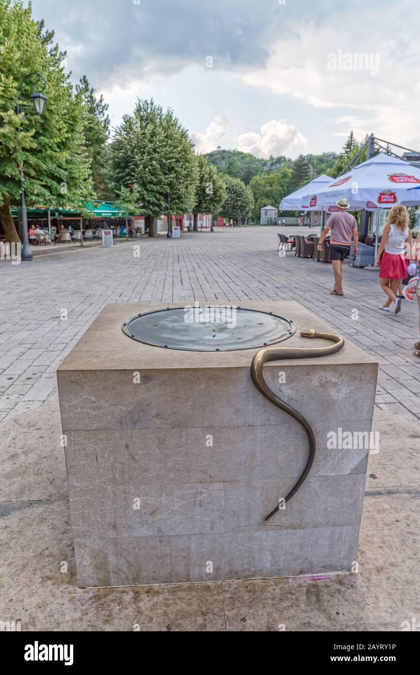 Cetinje snake on the well Stock Photo - Alamy