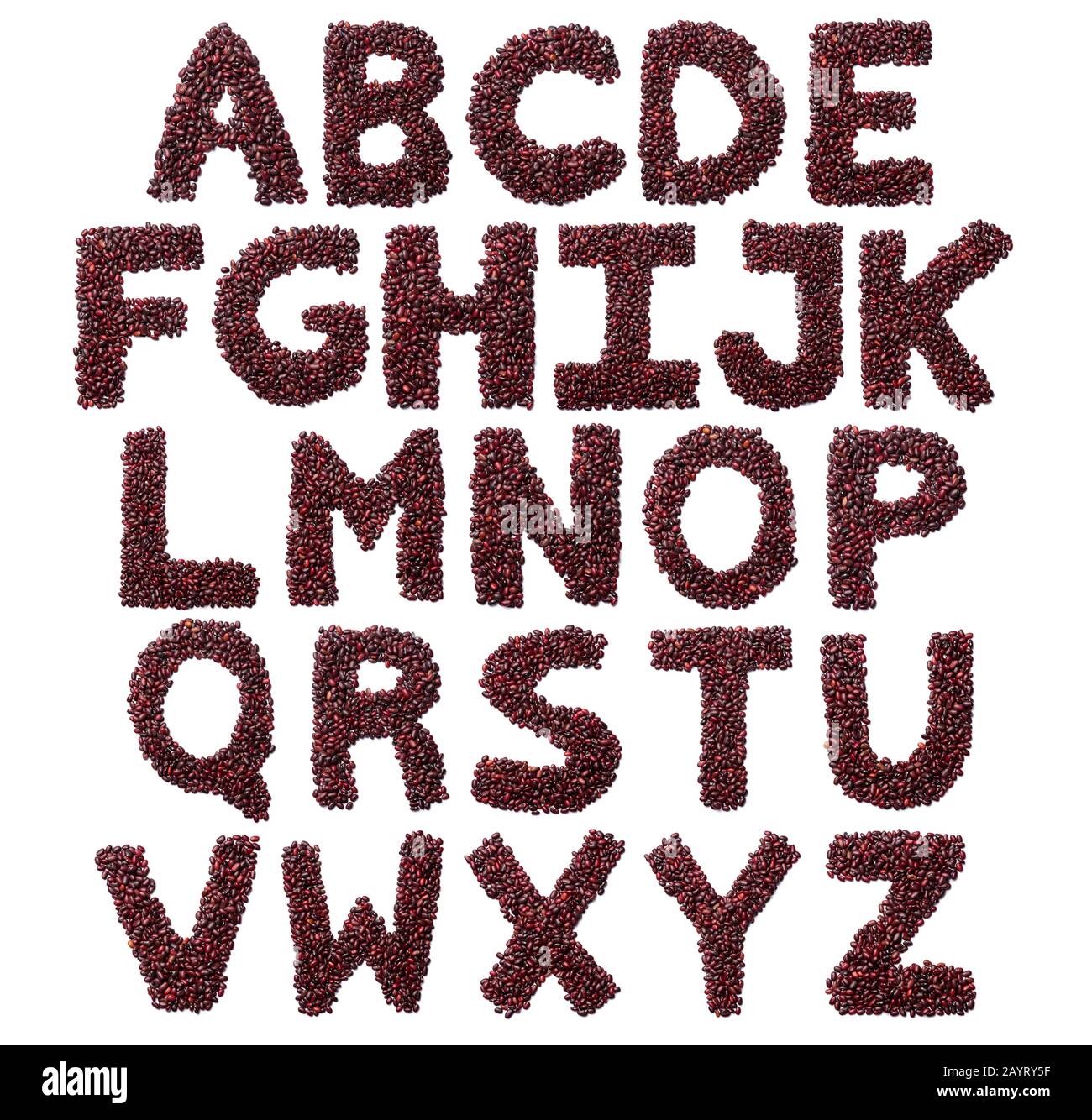English alphabet from brown beans on a white isolated background. Brown ...