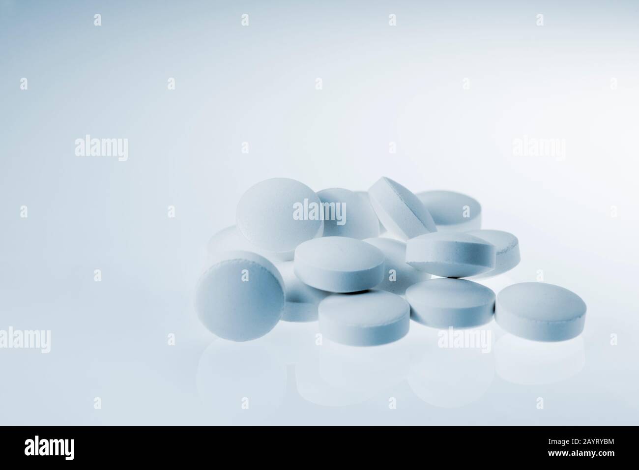 Closeup of piled round tablets isolated on white background in ...