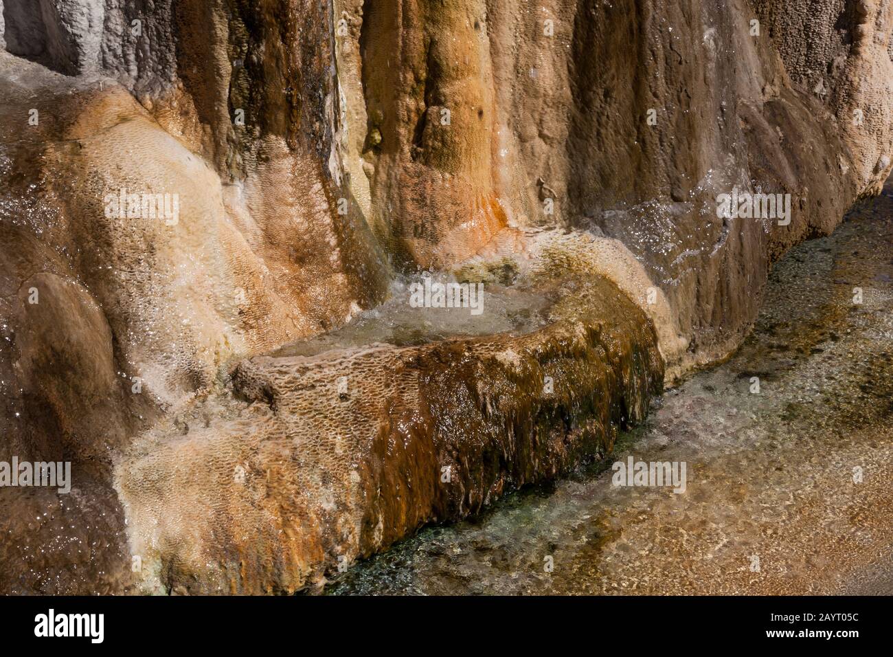 Hot mineral water flowing over a rock pyramid base for over a hundred ...