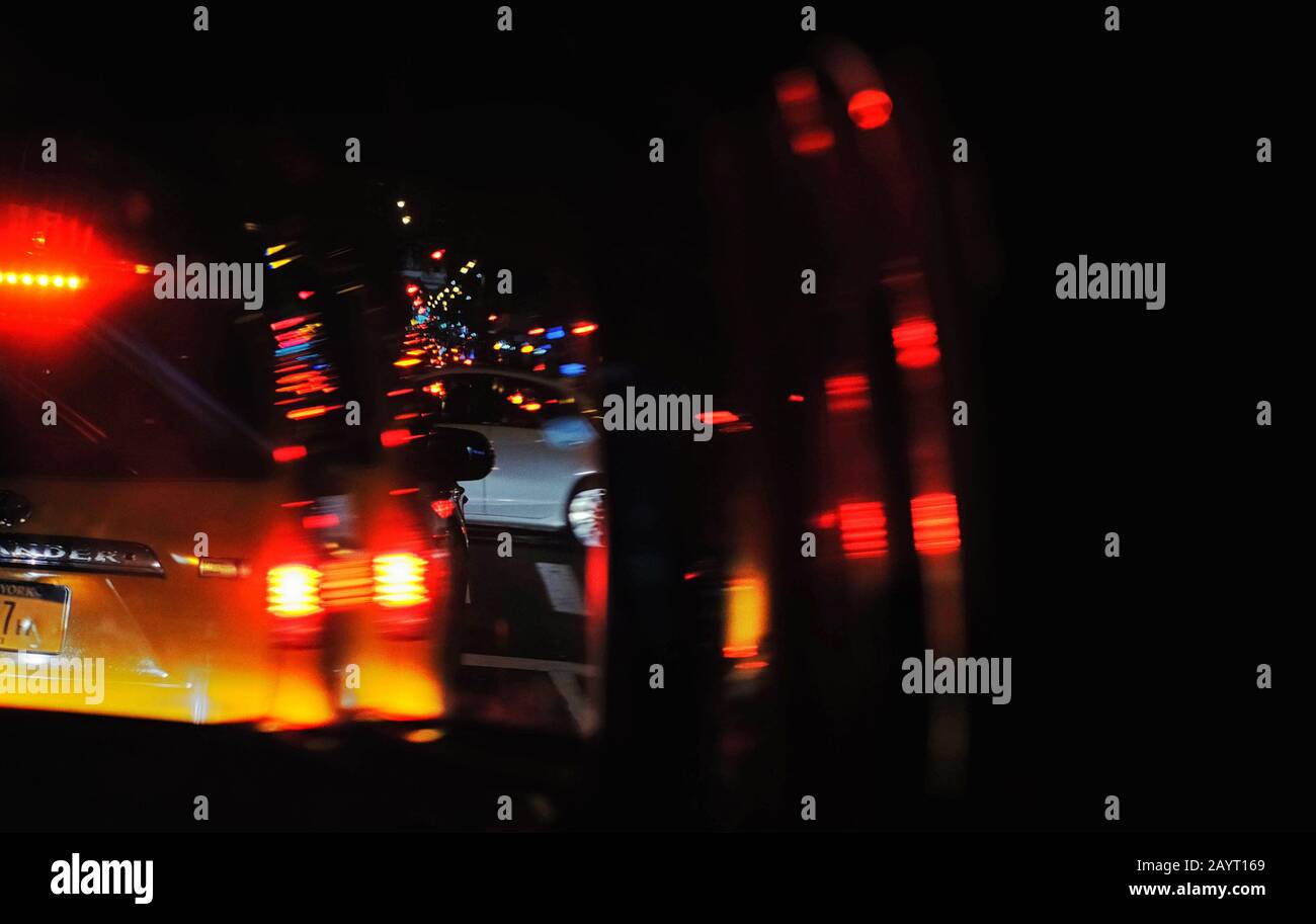 Red tail lights - reflected and multiplied as an abstract night driving ...