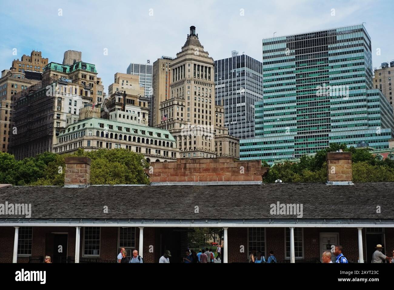 Inside Castle Clinton with art deco skyscrapers of Wall Street and the ...