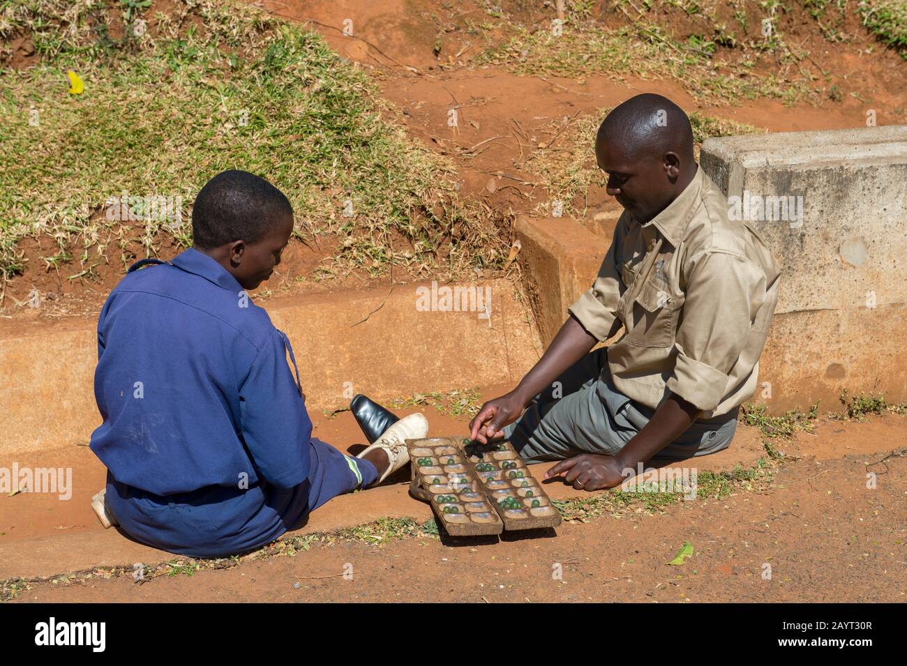 Men playing the game of Mancala, which is an ancient African game ...