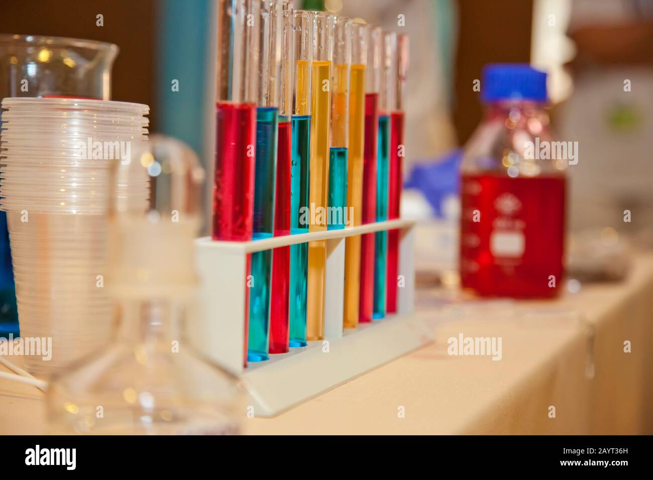 numerous multi-colored test tubes with different chemicals are placed ...