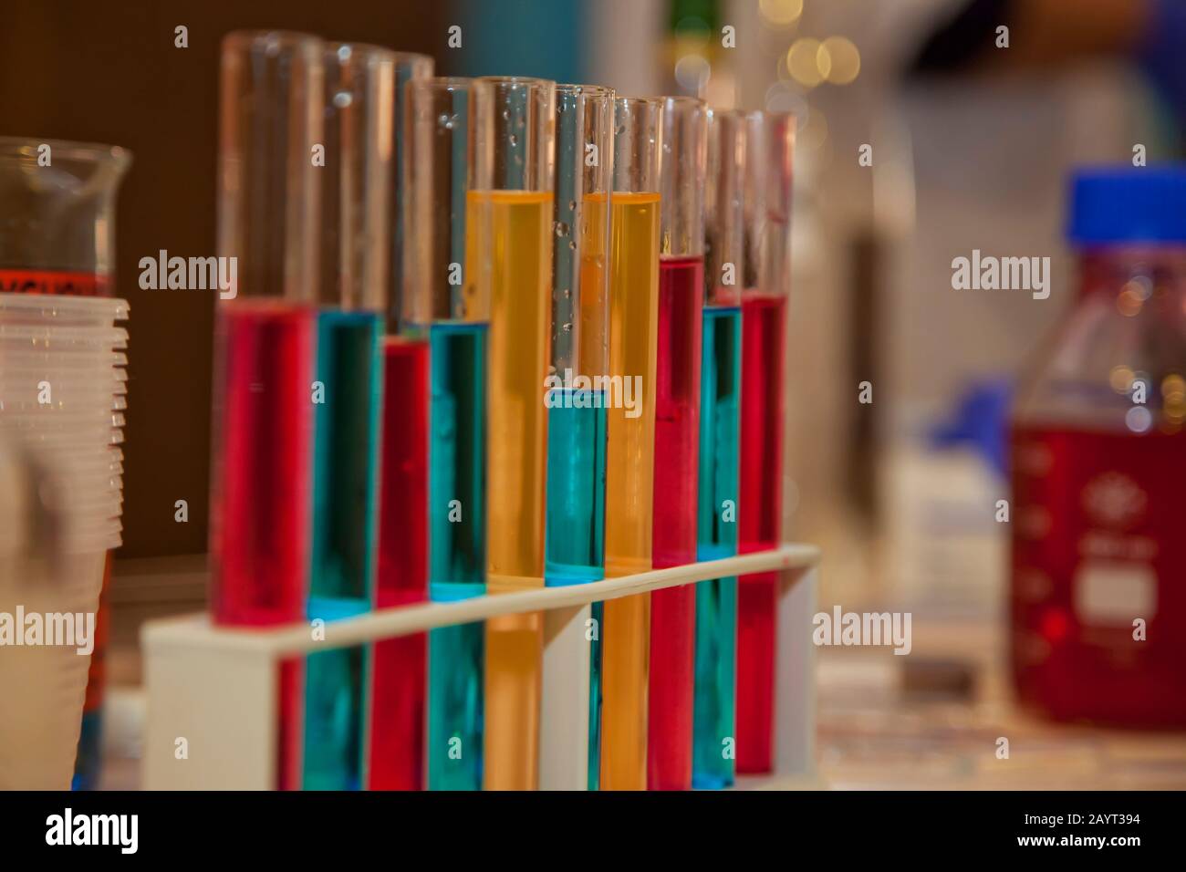 numerous multi-colored test tubes with different chemicals are placed ...