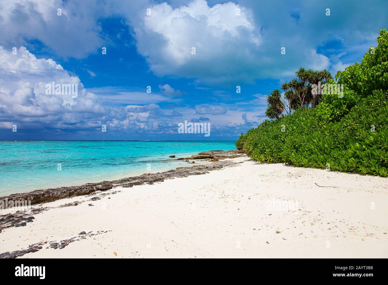 Turquoise blue sea water shore and cloudy sky Stock Photo - Alamy
