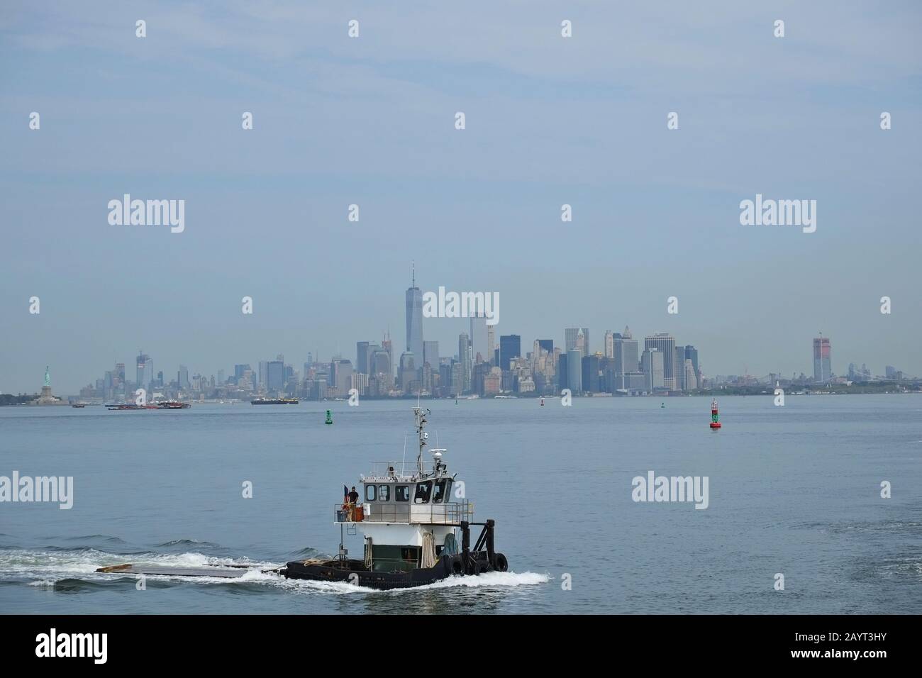 A small utility 'tub' boat towing a water sled on Upper Bay seen from ...